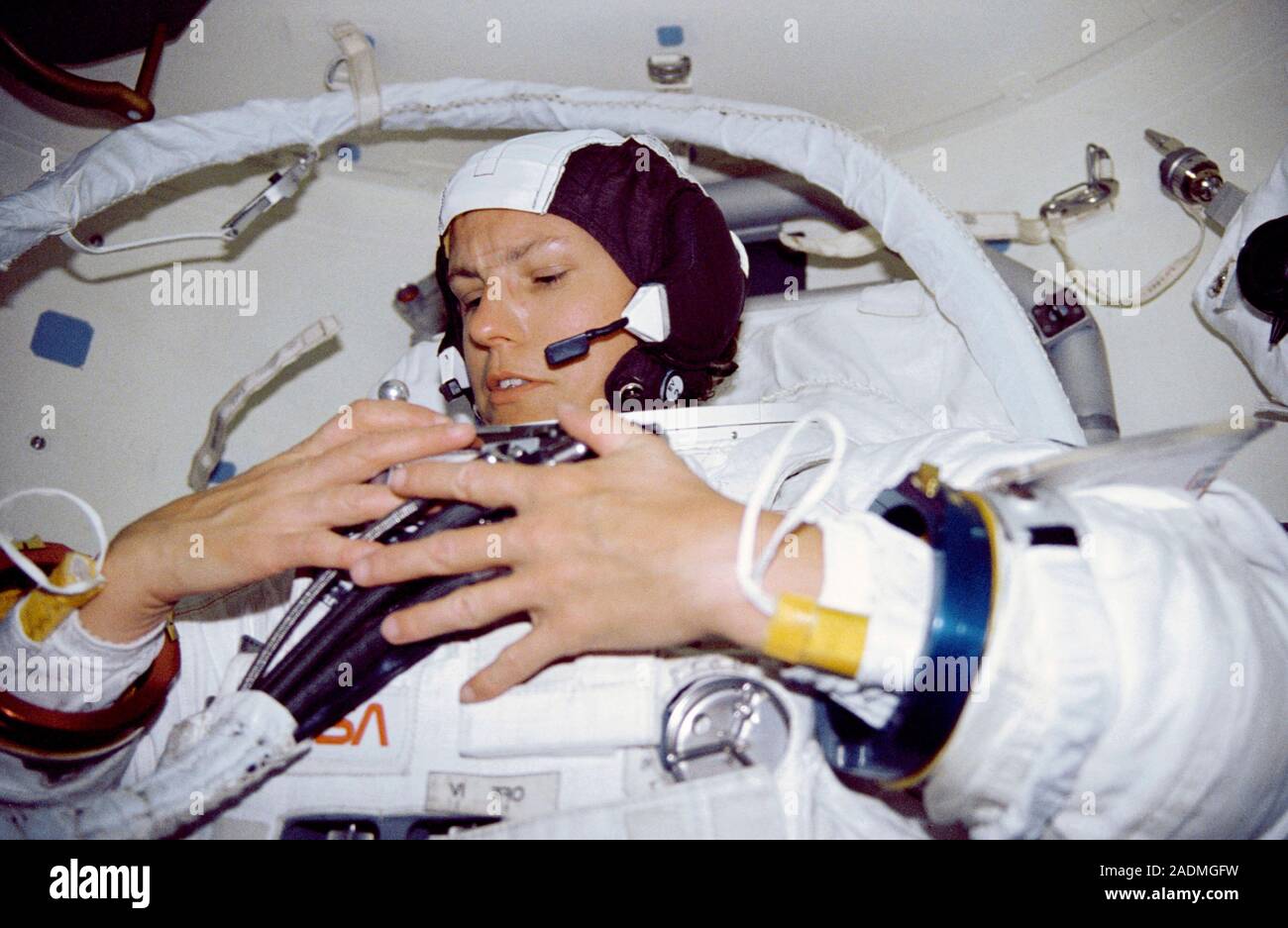 Astronaut Kathryn Sullivan standing by in her Extravehicular Mobility Unit (EMU) suit in the ...