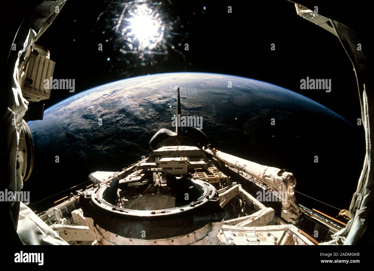 Earth from Shuttle. Fish-eye view of sunrise over Earth from the cargo bay of the Space Shuttle ...