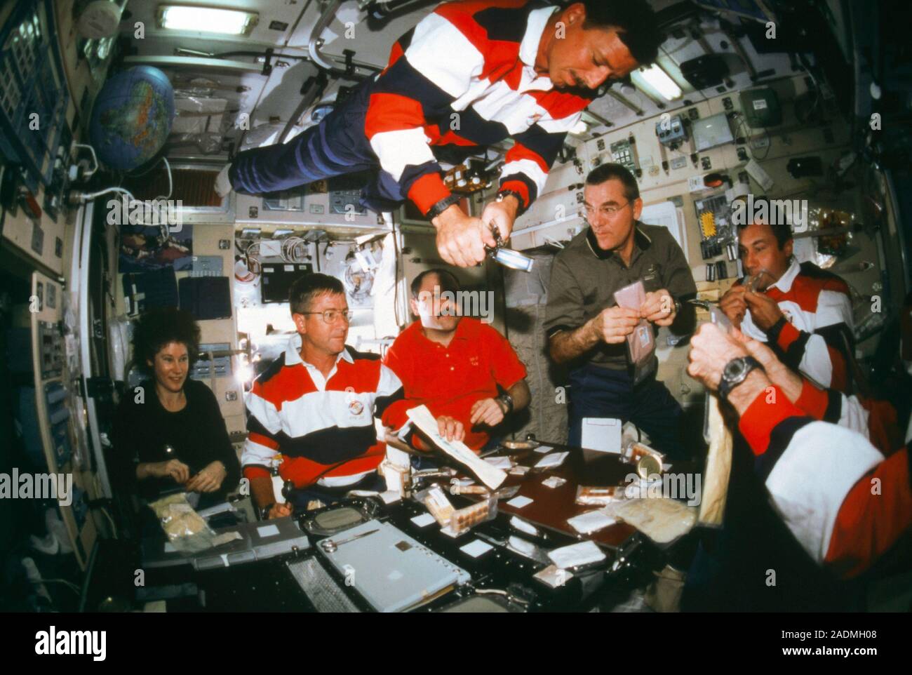 ISS astronauts sharing a meal in the Zvezda module of the International ...