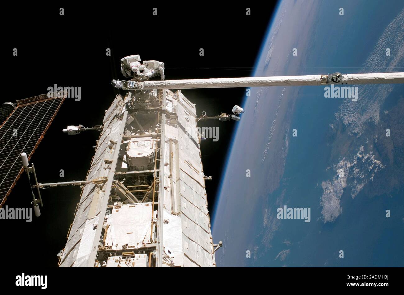 ISS space walk. British astronaut Piers Sellers (born 1955, red stripes ...