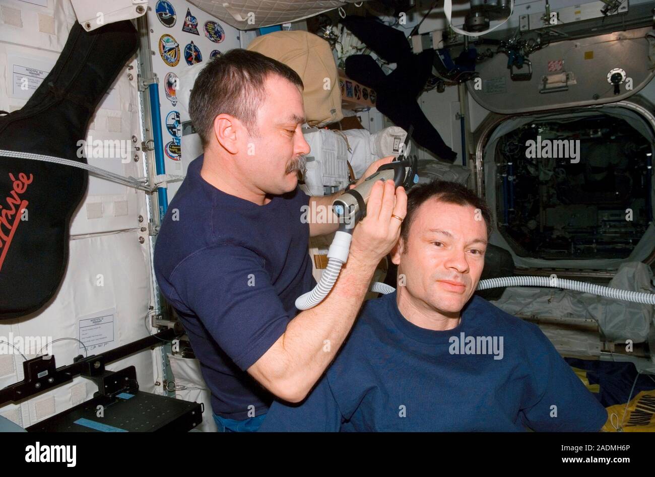 Astronaut having his hair cut in space. Russian cosmonaut Mikhail ...