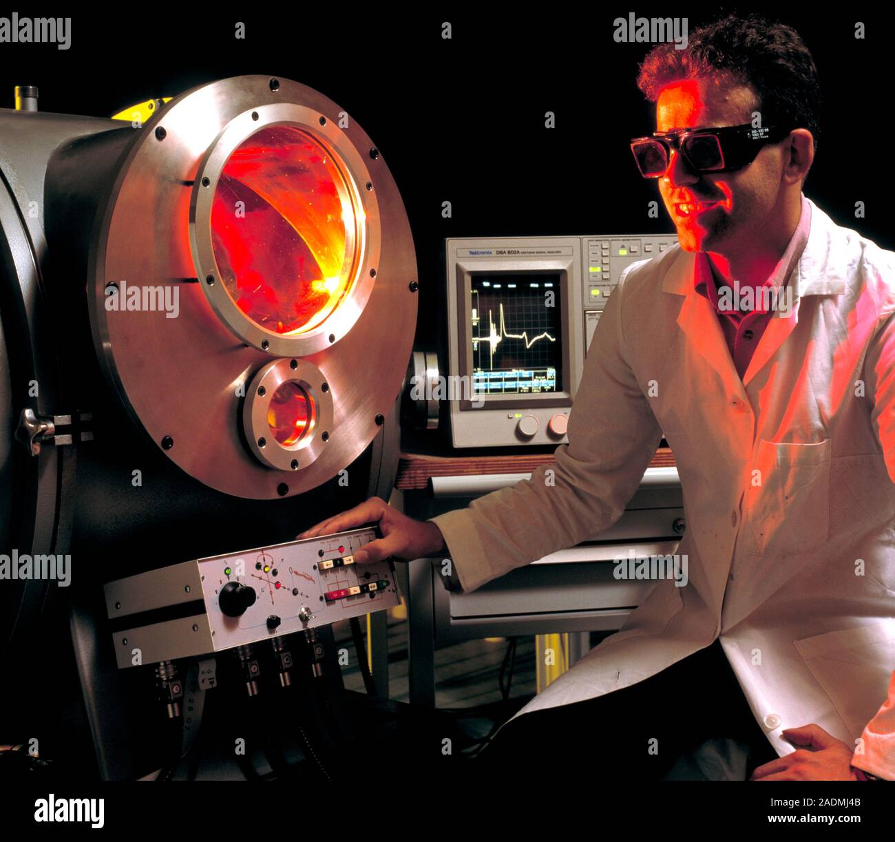 Simulating micrometeoroid impacts. Researcher studying the effect of ...