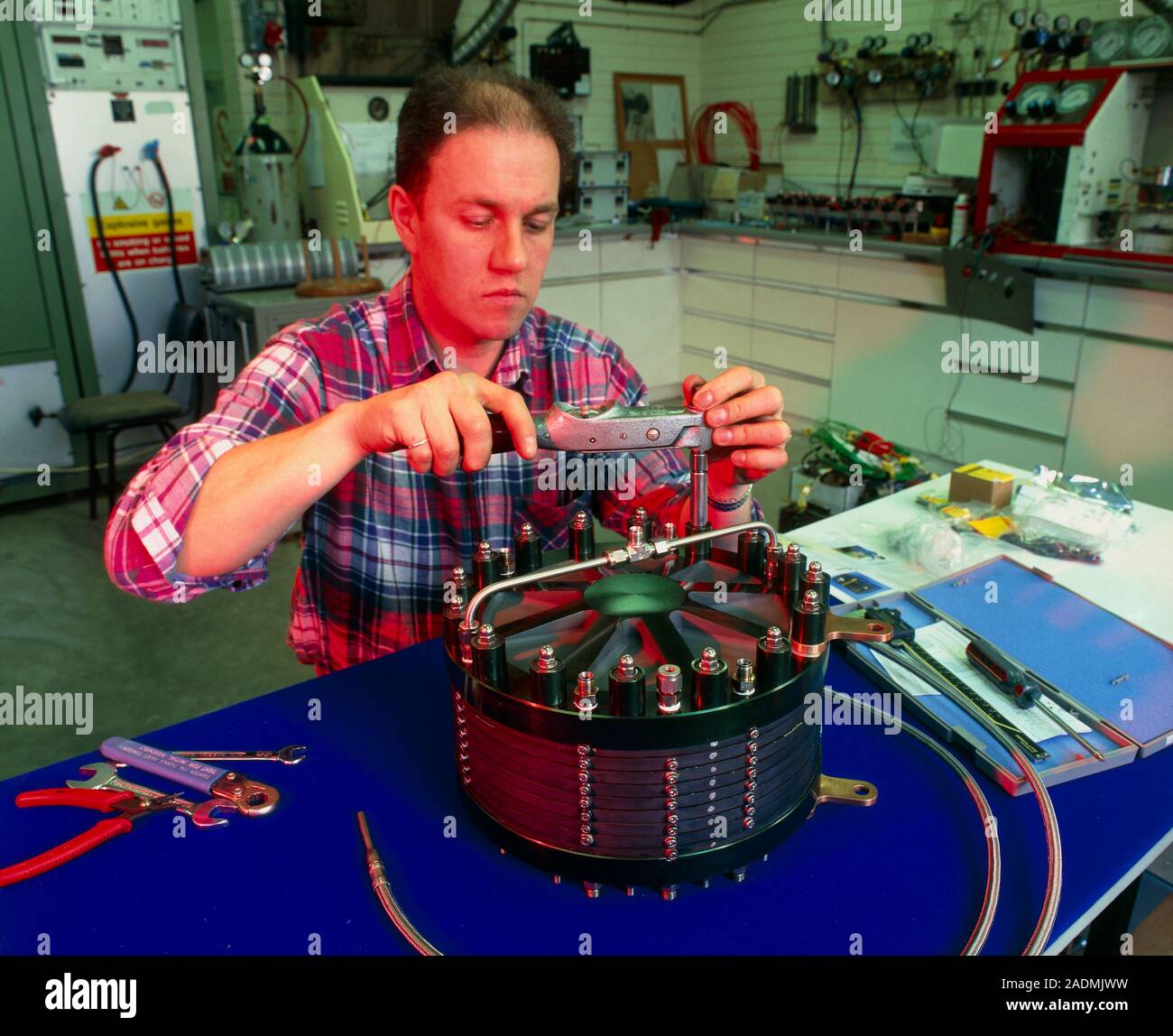 Fuel cell testing. Technician assembling a Solid Polymer Fuel Cell ...