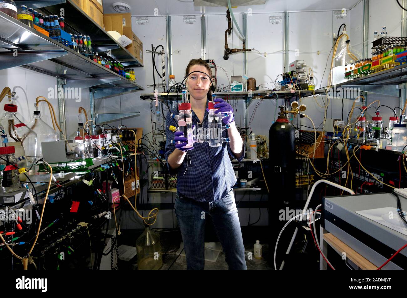 Microbial fuel cell research. Researcher holding a two-chambered ...