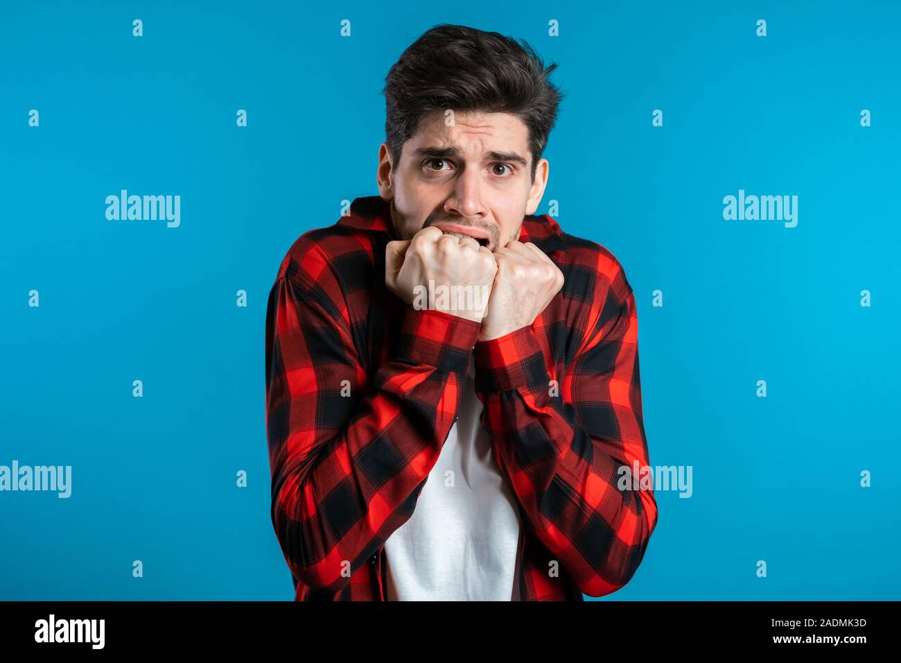 Frightened european man afraid of something and looks into camera with ...