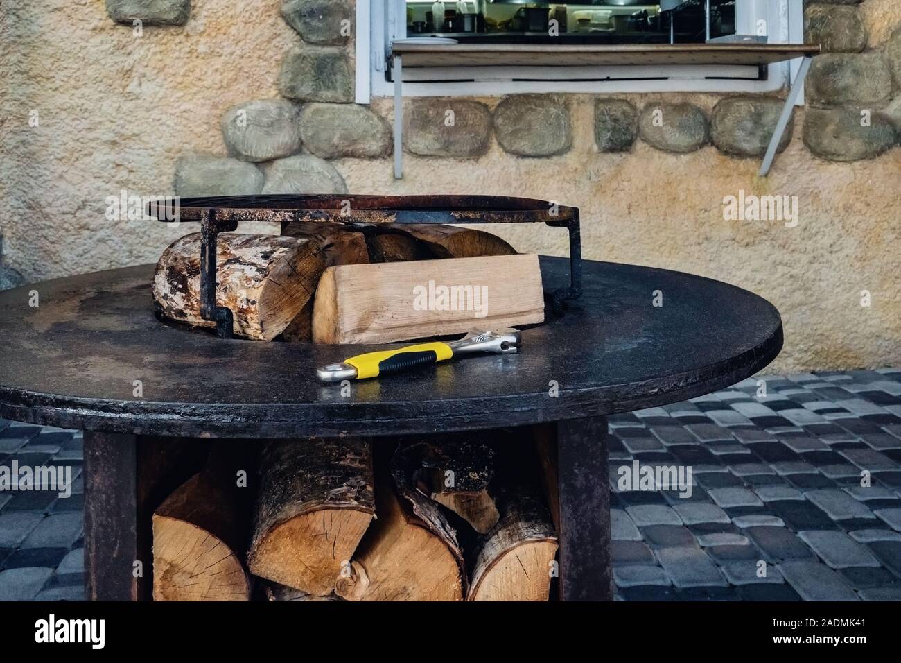 Outdoor wood-burning grill for frying steaks and pork ribs over an open ...