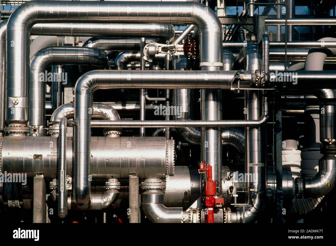 Oil refinery. Pipework at an oil refinery. In an oil refinery, crude ...