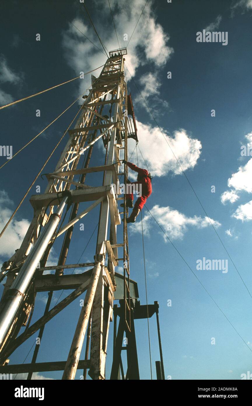 Oil drilling rig. Worker climbing an onshore oil drilling rig. These ...