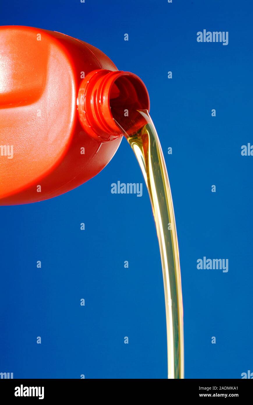 Pouring motor oil. This is used to lubricate moving parts, typically in ...