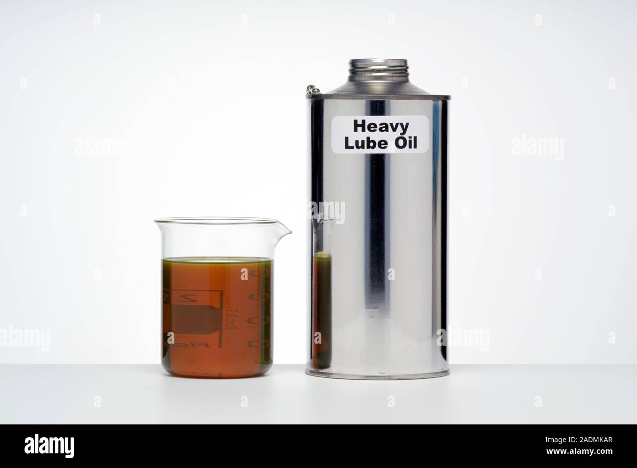 Heavy lubricating oil in a beaker. Lubricating oil is a product of the ...