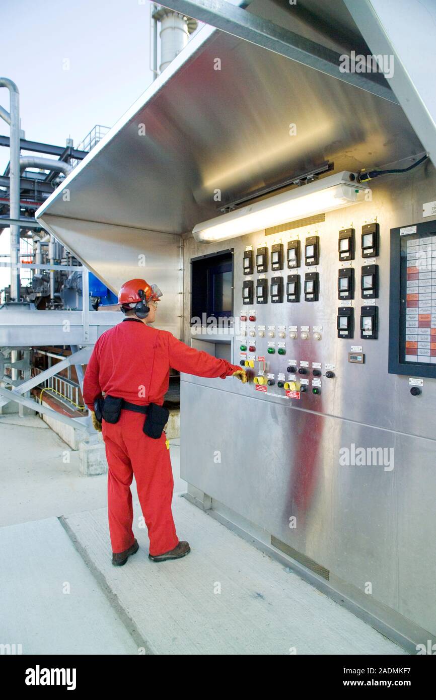 Oil refinery worker checking the alarmed control panel for the ...