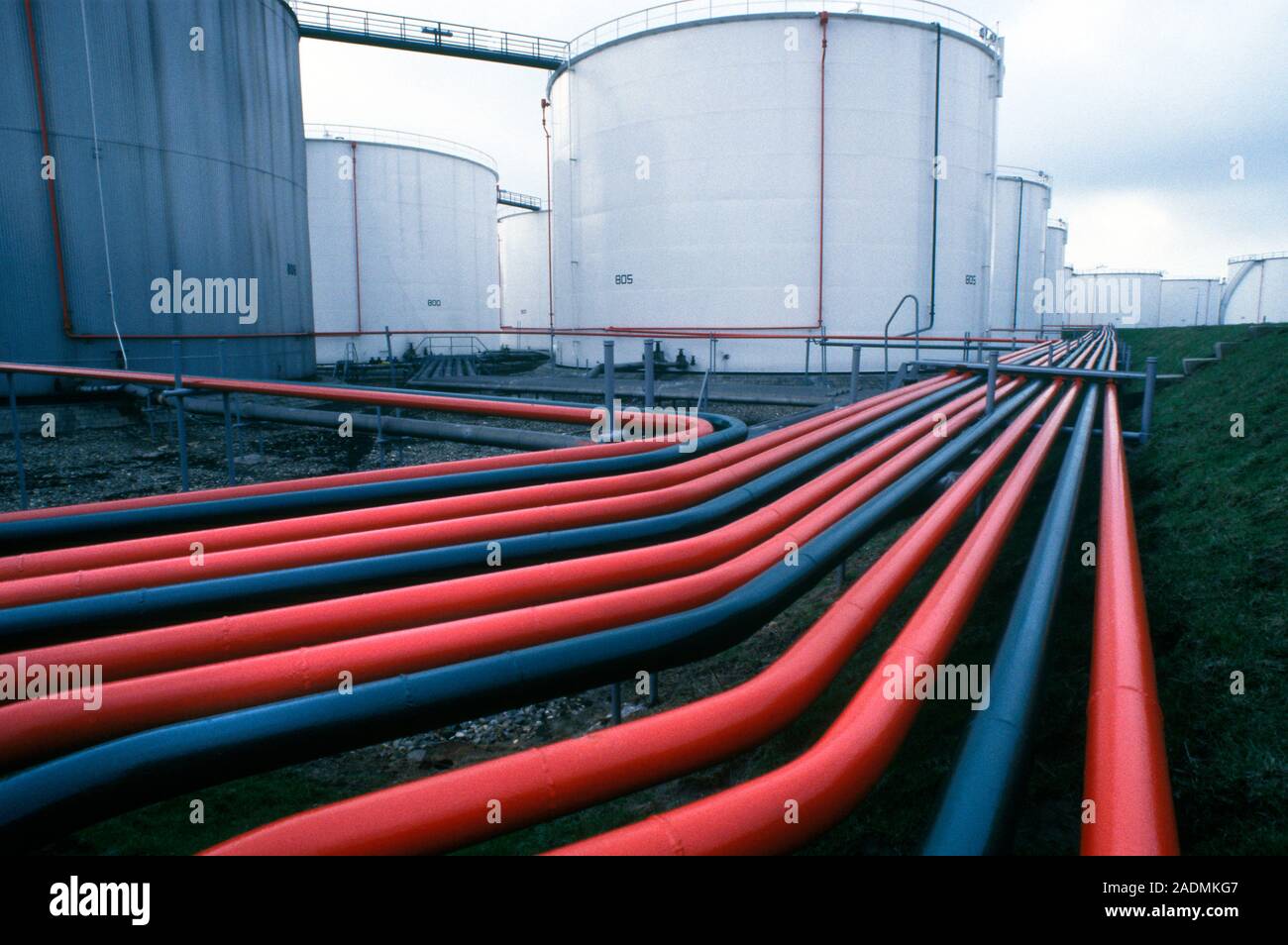 Pipes and storage tanks at an oil refinery Stock Photo - Alamy