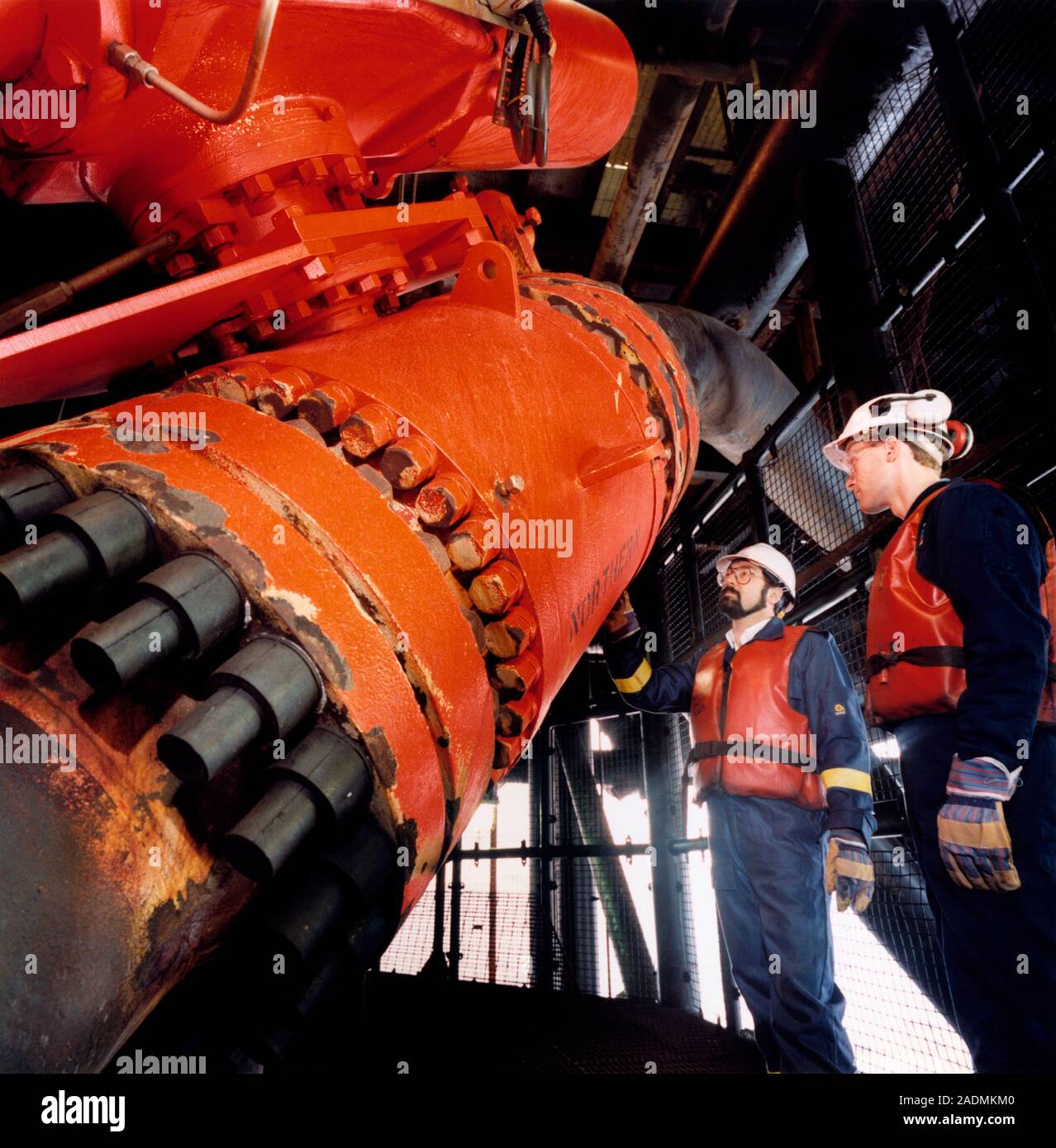 Oil rig inspection. Technicians examine a pipe on a North Sea oil rig ...