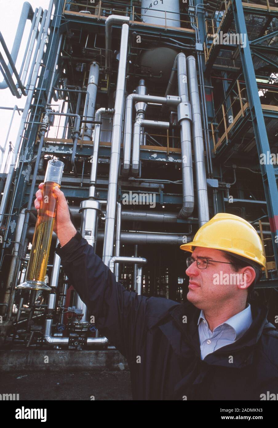 Biodiesel manufacture. Biofuel production plant worker holding a sample ...