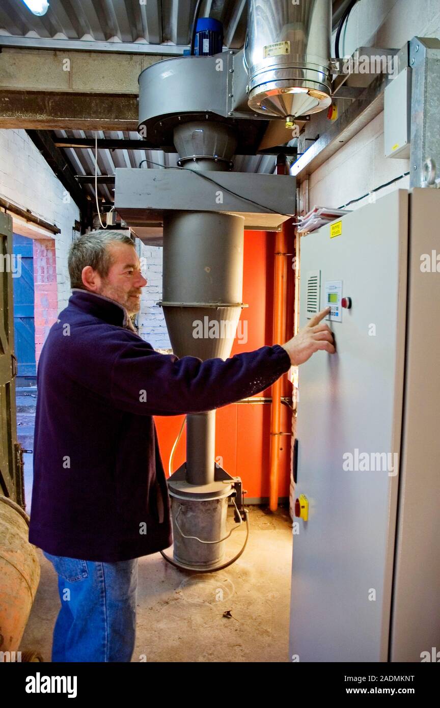 MODEL RELEASED. Wood furnace heating. Operator checking the control ...