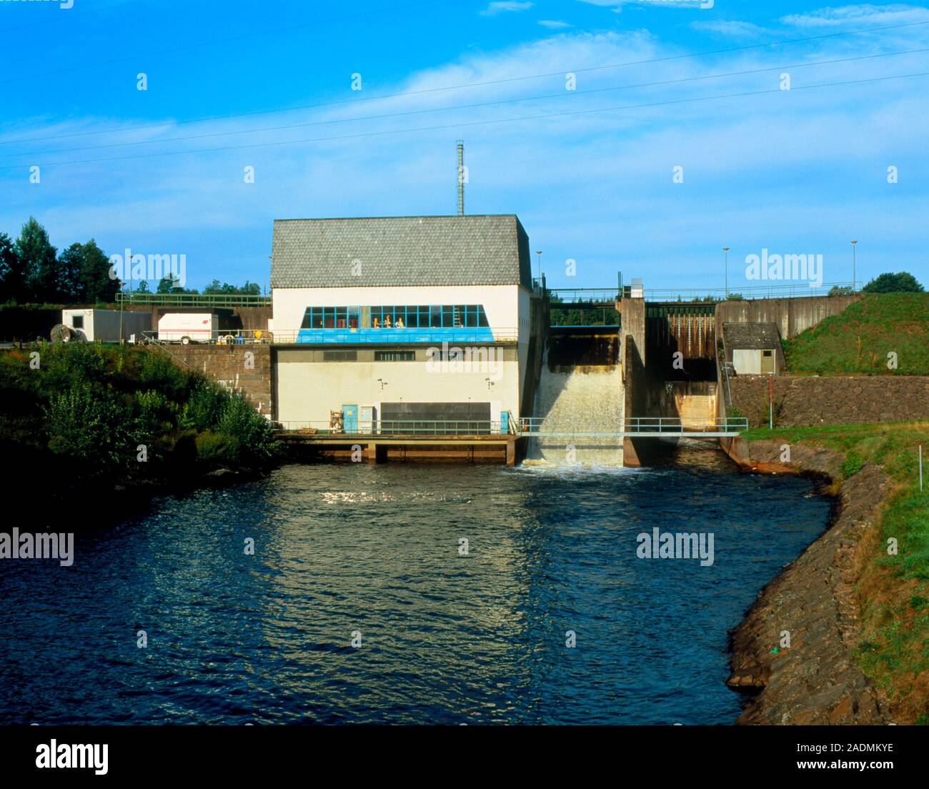 Small-scale hydroelectric power. View of the dam and turbine hall of a ...