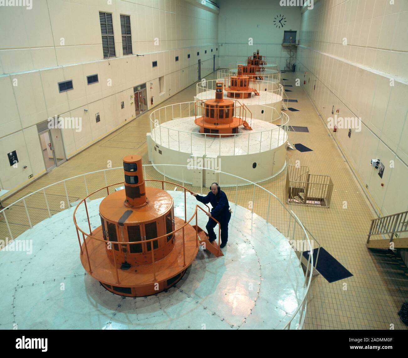 Hydroelectric power station. Technician on one of six generators at a ...