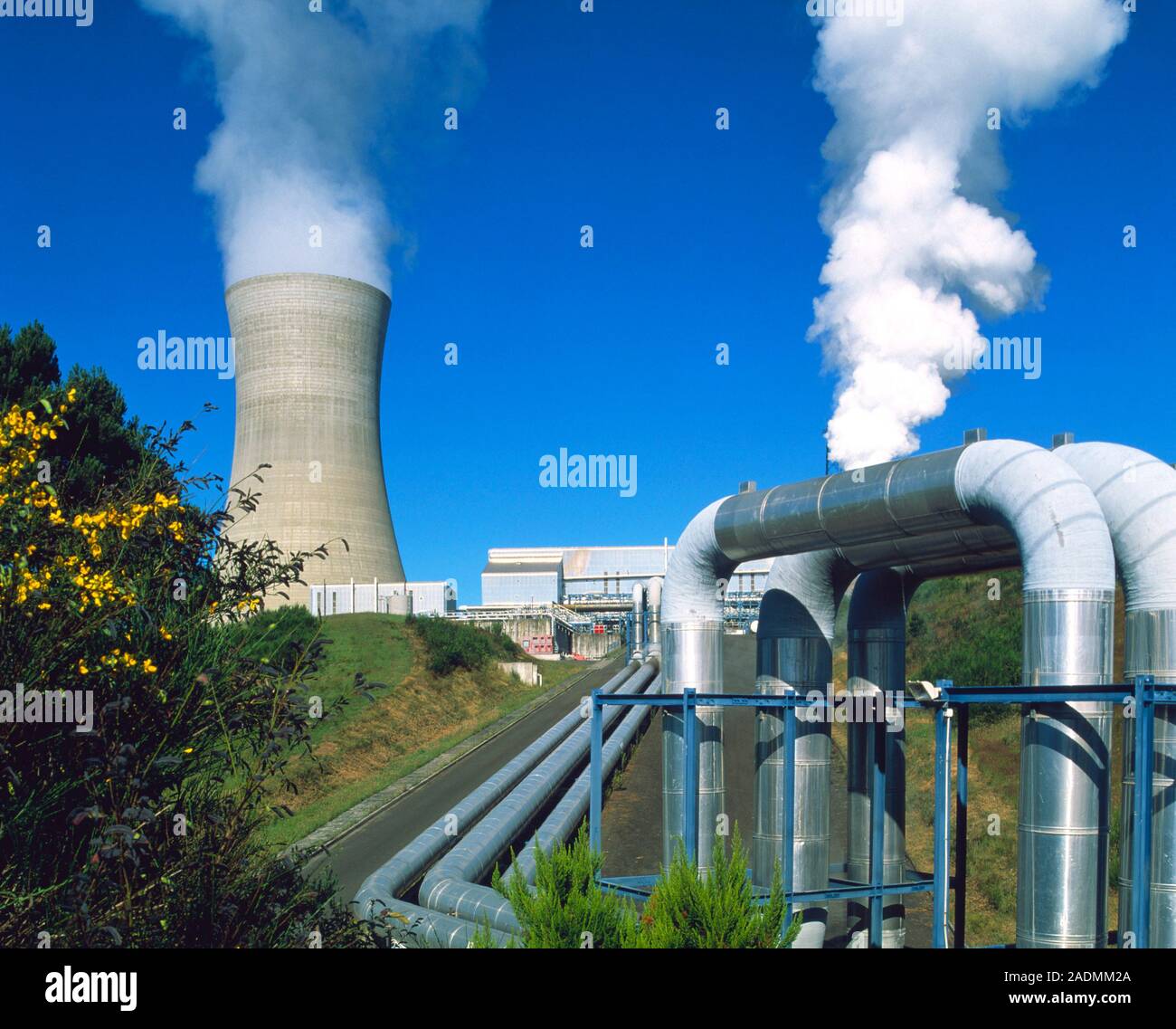 Geothermal power. Steam-carrying pipes and a cooling tower at the ...