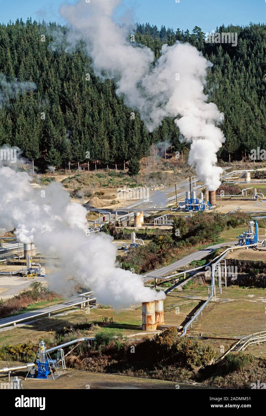 Geothermal power station. Steam rises from a network of insulated pipes ...