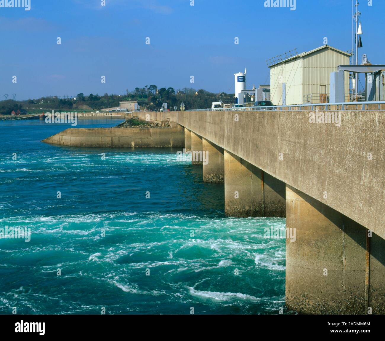 Tidal barrage. Swirling water entering through sluice gates on a tidal ...