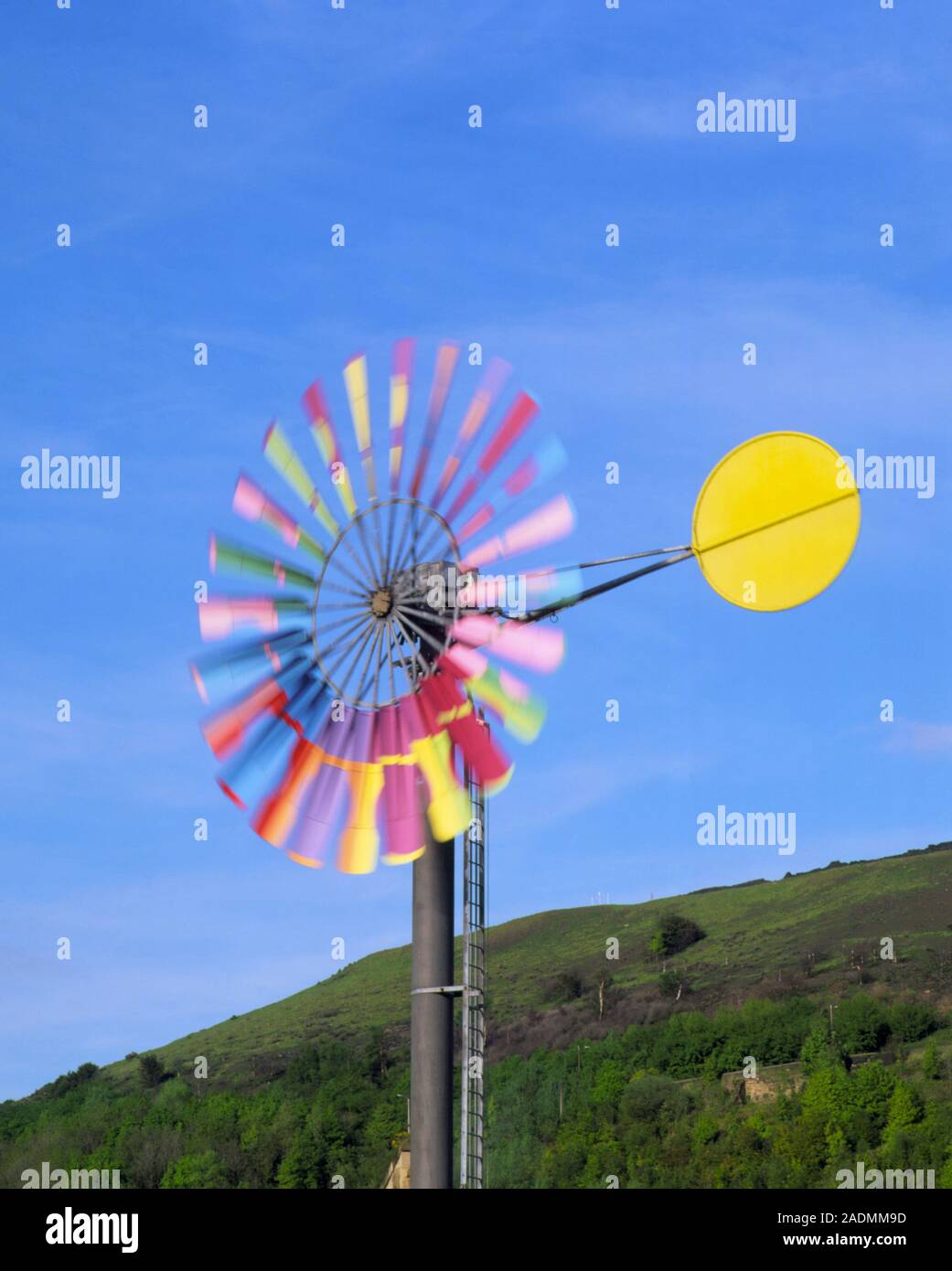 Windmill. View of a spinning windmill. The large yellow disc (centre ...