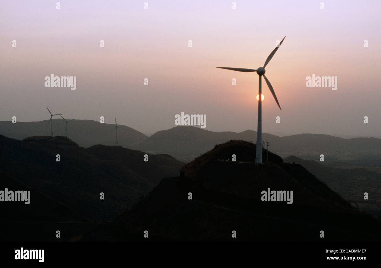 Wind farm at sunset. These wind turbines are used to generate ...