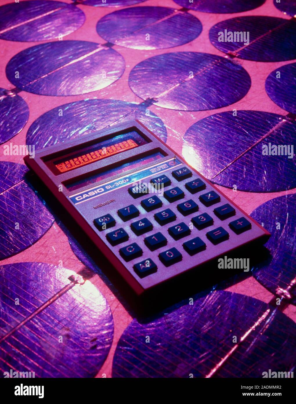 Solar-powered calculator resting on photovoltaic cells. Photovoltaic ...