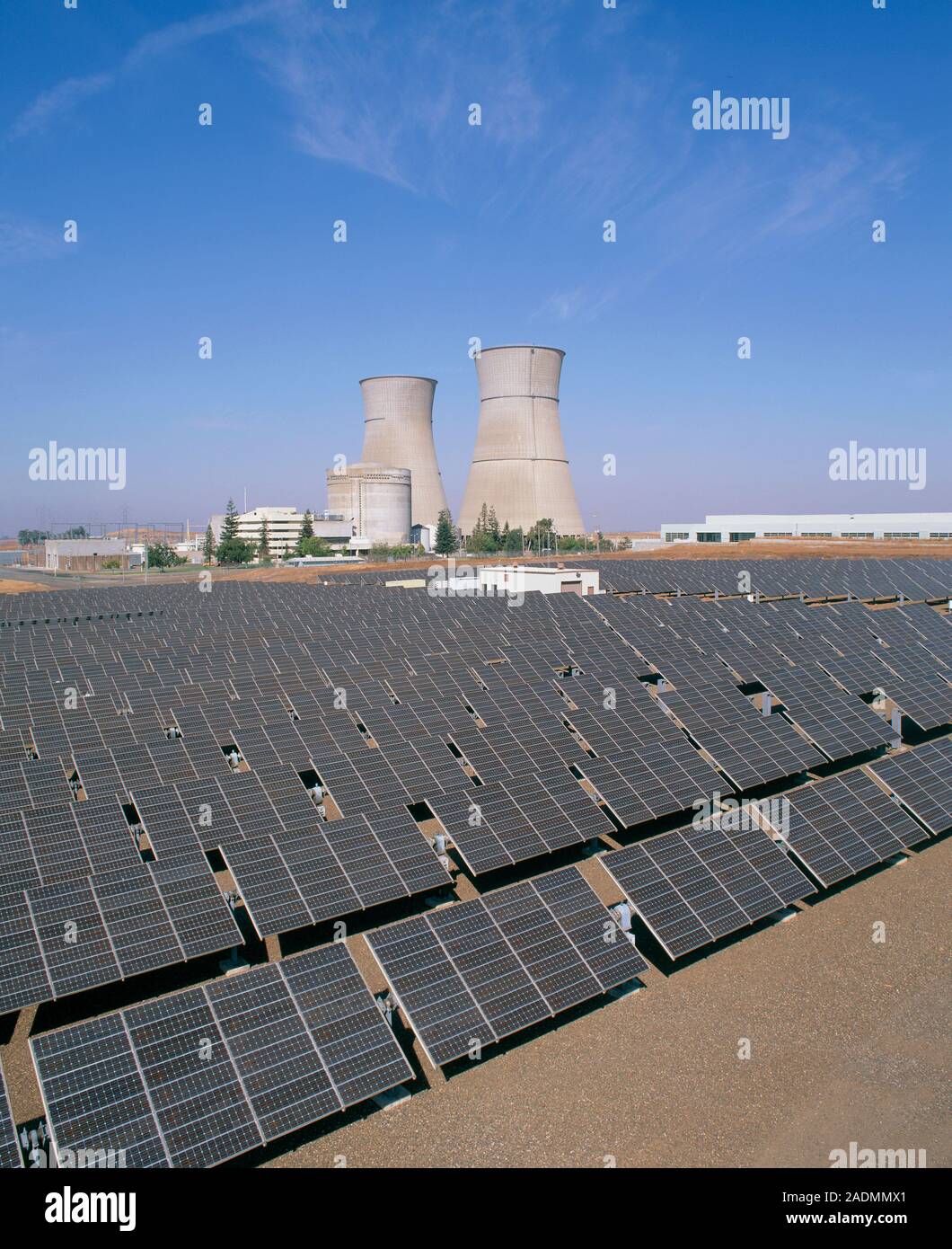 Solar power station. Array of solar panels (lower frame) at a solar ...