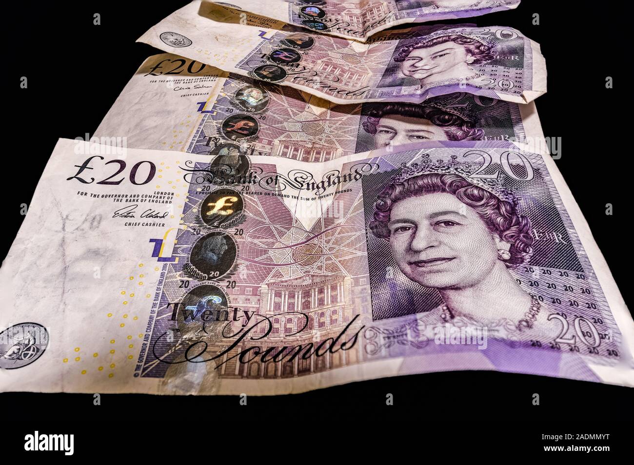 twenty pound notes on black background Stock Photo - Alamy