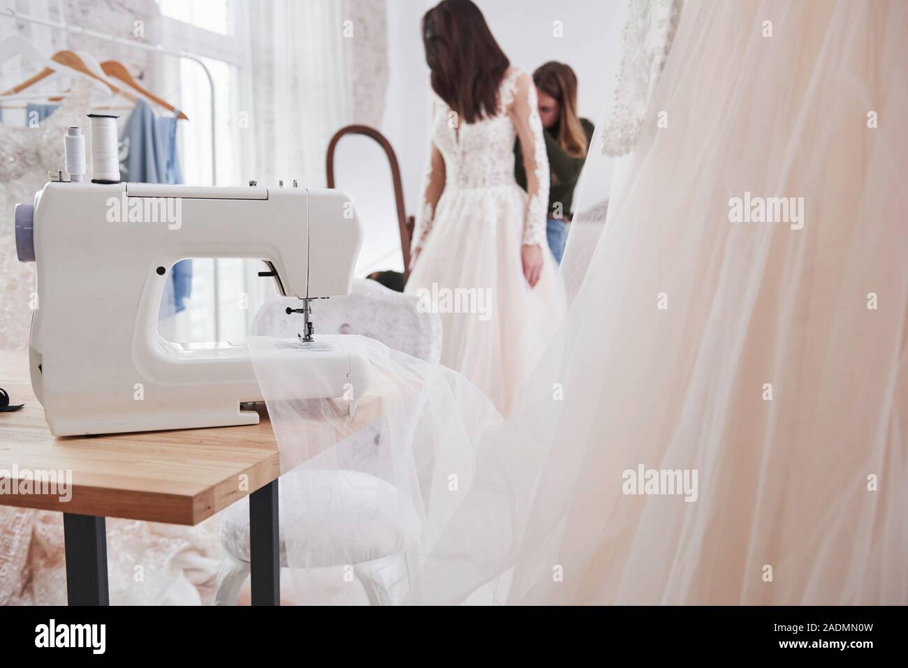 Focused photo. The process of fitting the dress in the studio of hand ...