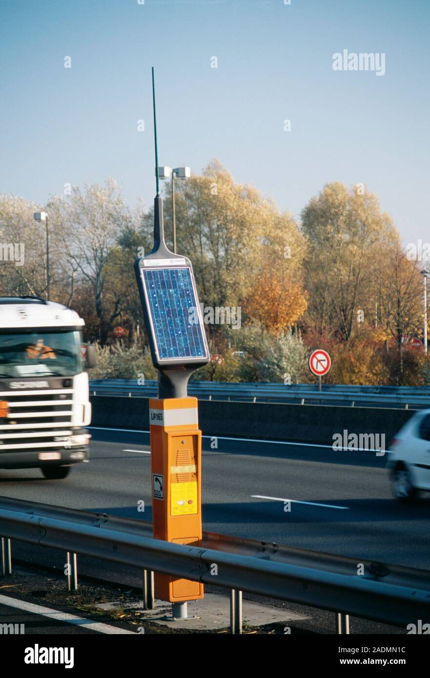 Solar-powered emergency telephone at the side of a motorway. The solar ...