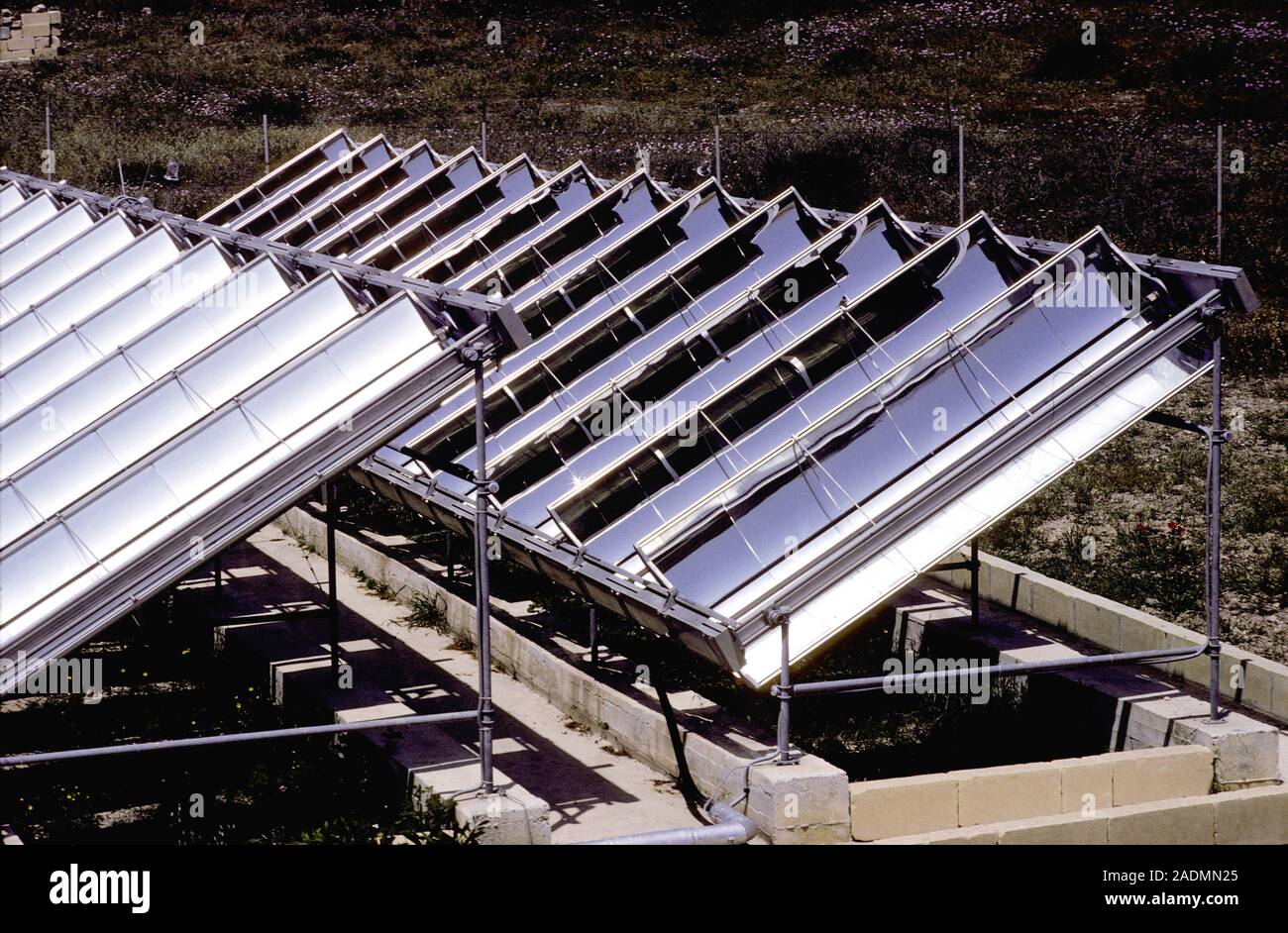 Solar water heaters. Each heater in the array has parabolic mirrors ...