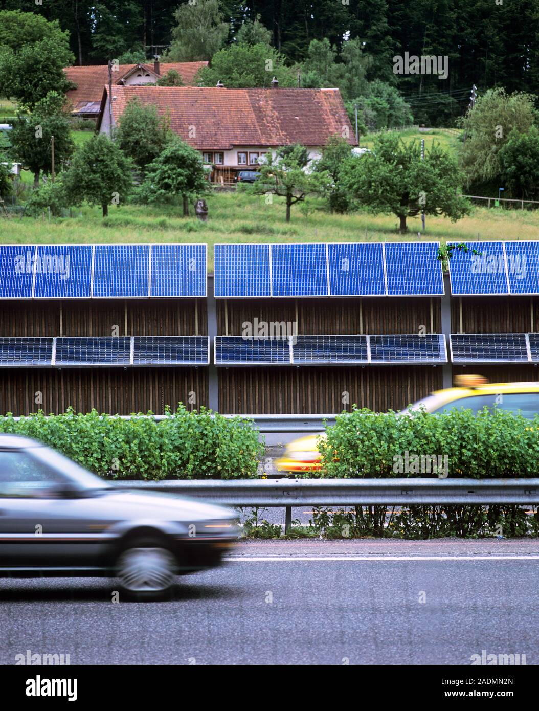 Solar panels by a motorway. The solar panels consist of photovoltaic ...