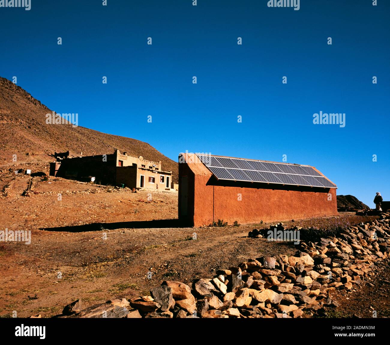 Solar array. Photovoltaic modules on a wall at a remote mountain refuge ...