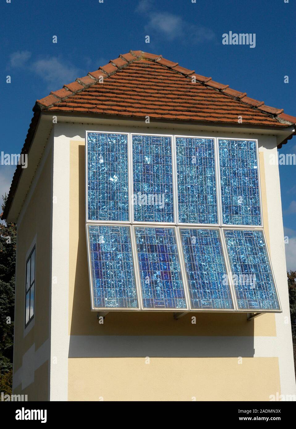 Domestic solar panels on the side of a house. Each solar, or ...