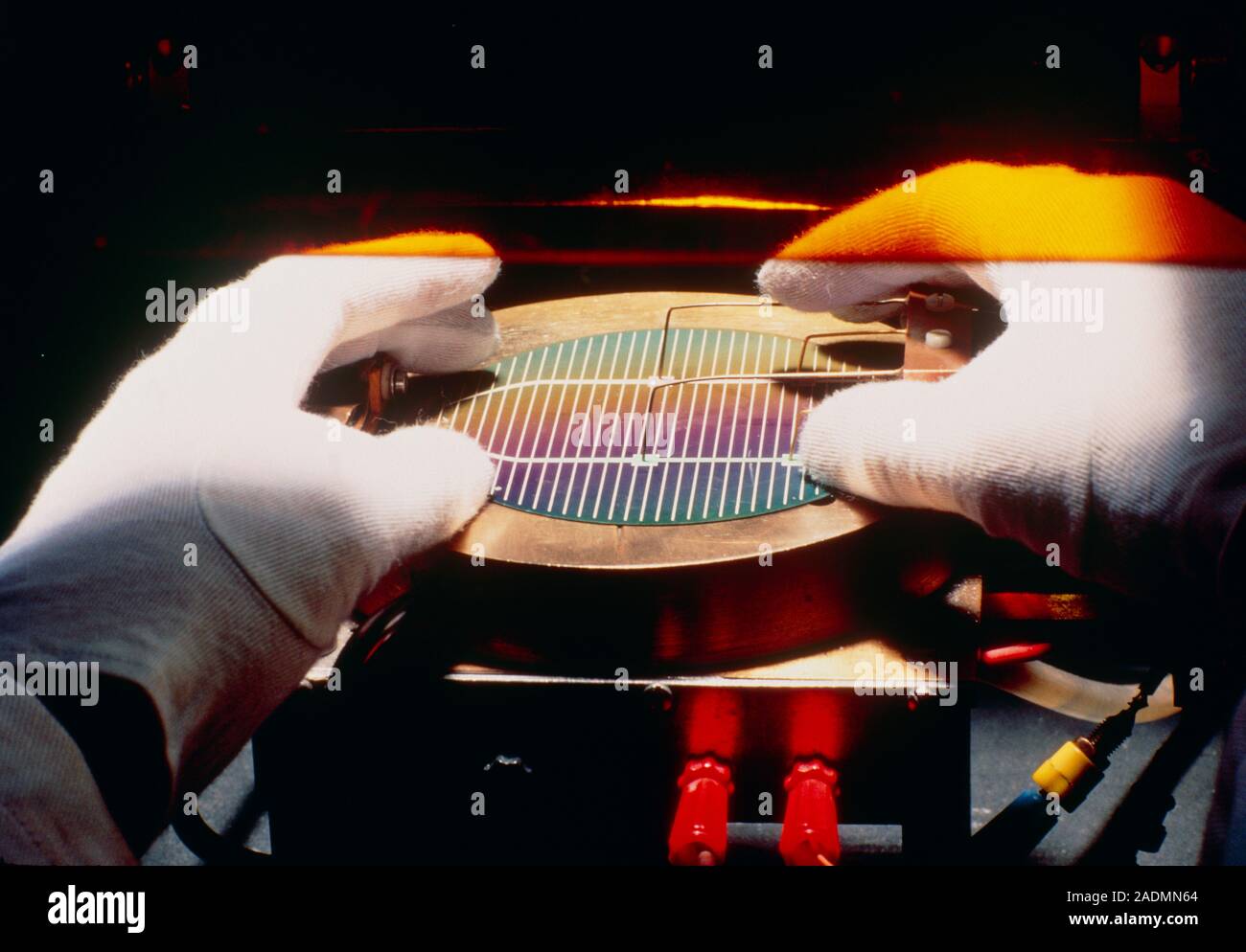 Solar cell manufacture. A finished solar cell is tested at the solar ...