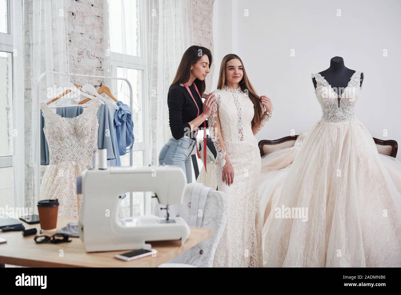 Woman is helping the girl. The process of fitting the dress in the ...