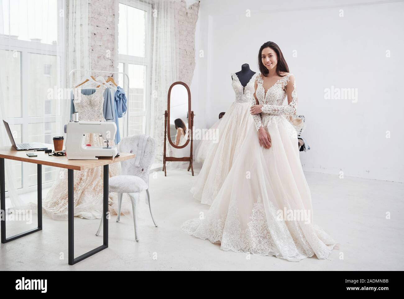 Girl smiling to the camera. The process of fitting the dress in the ...