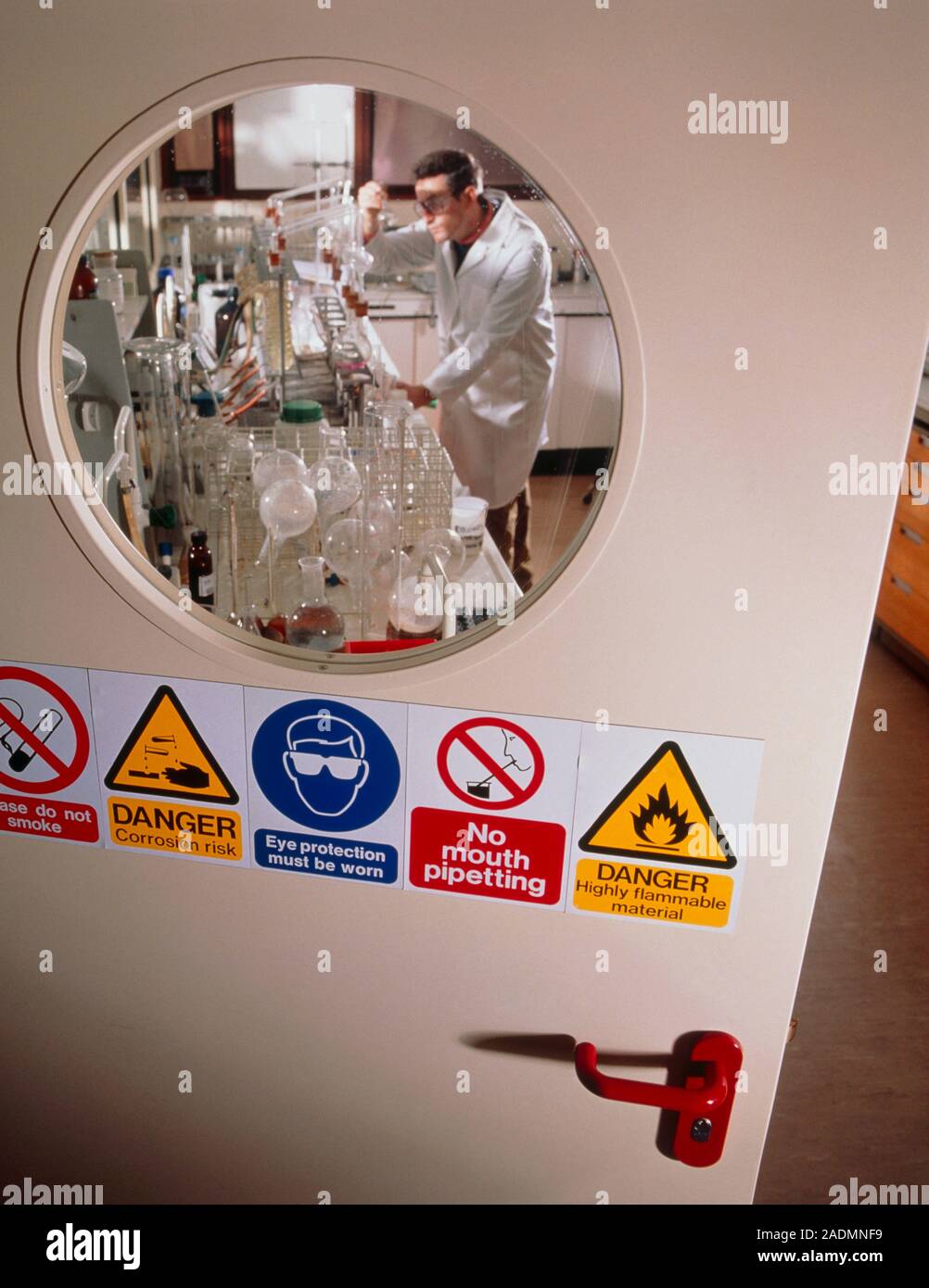 Laboratory safety signs. Safety signs seen on the door of a laboratory ...