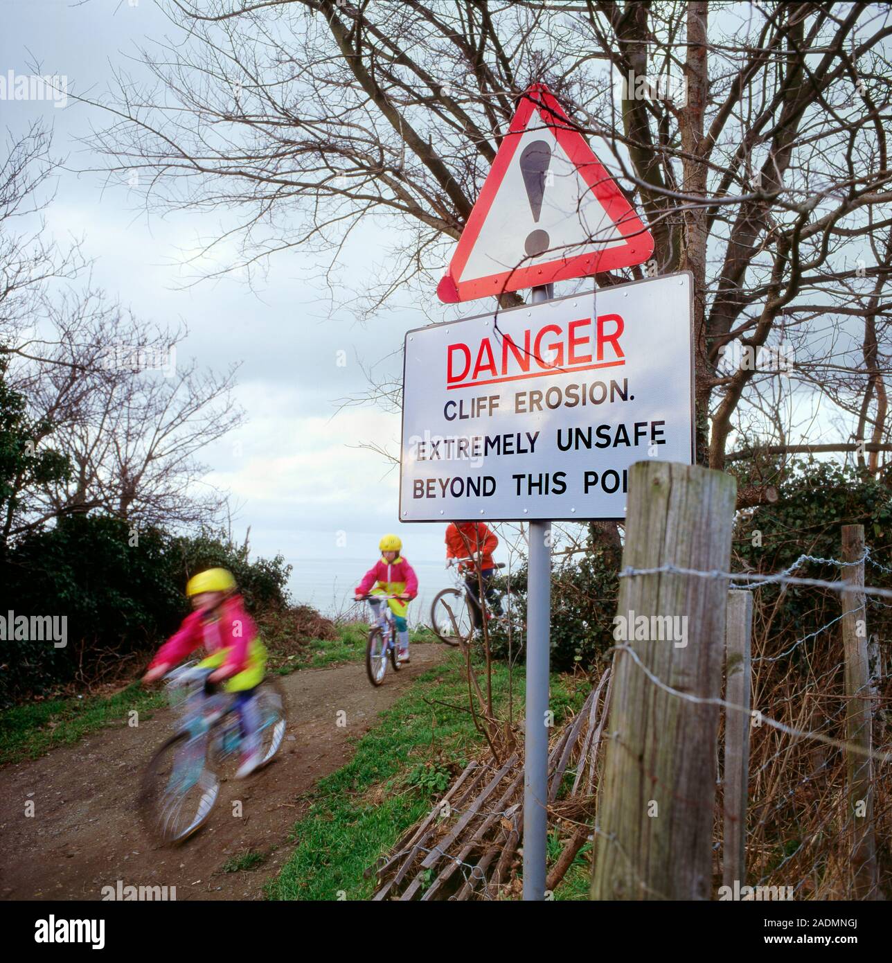 Erosion warning sign. Notice at the edge of a track warning of cliff ...
