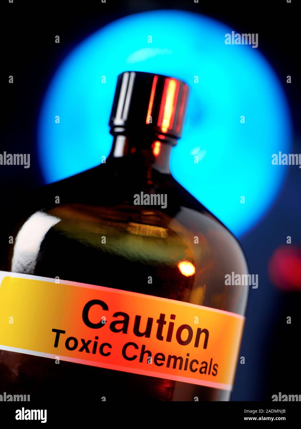 Hazardous chemical. Bottle labelled with a chemical hazard warning sign ...