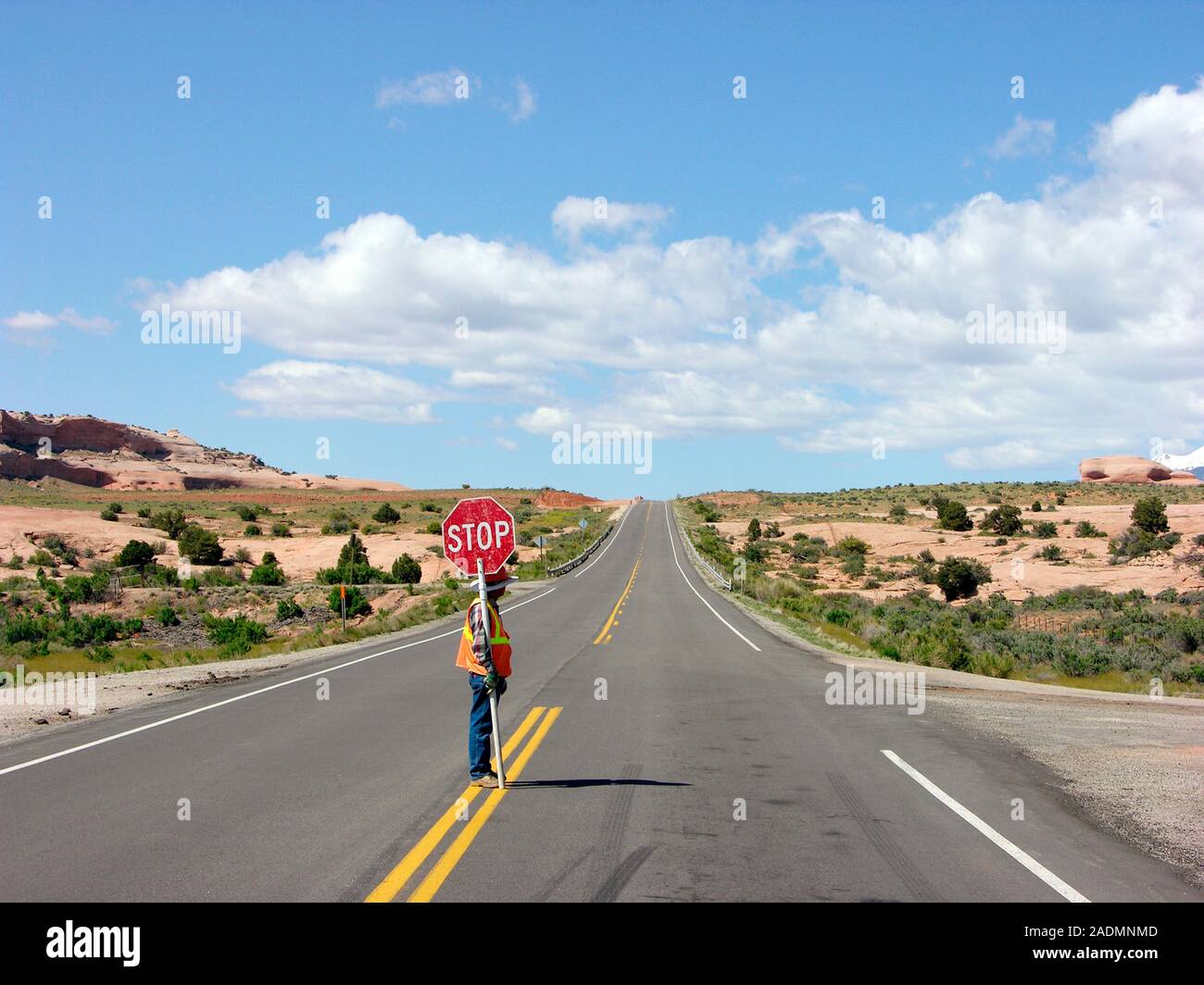 Stop sign. Construction worker holding a stop sign to control traffic ...