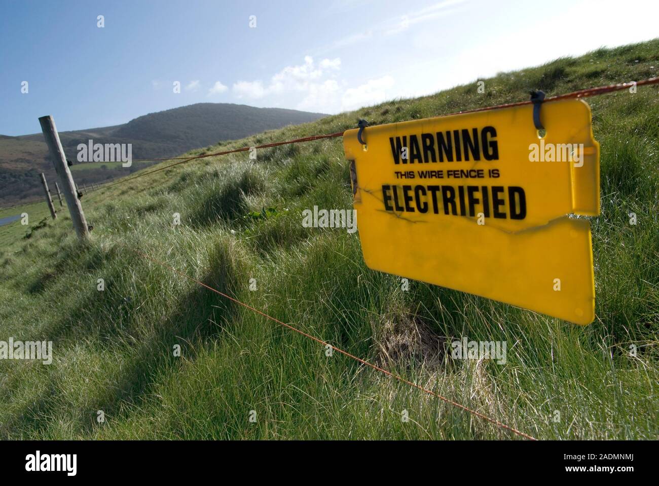 Electric fence warning sign on a salt marsh. Photographed in Porlock ...