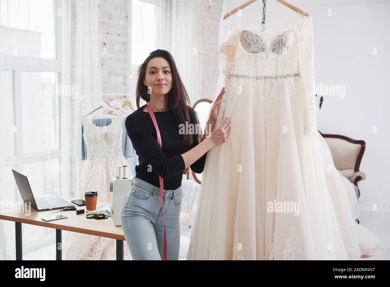 Showing off perfect dress. Female fashion designer works on the new ...