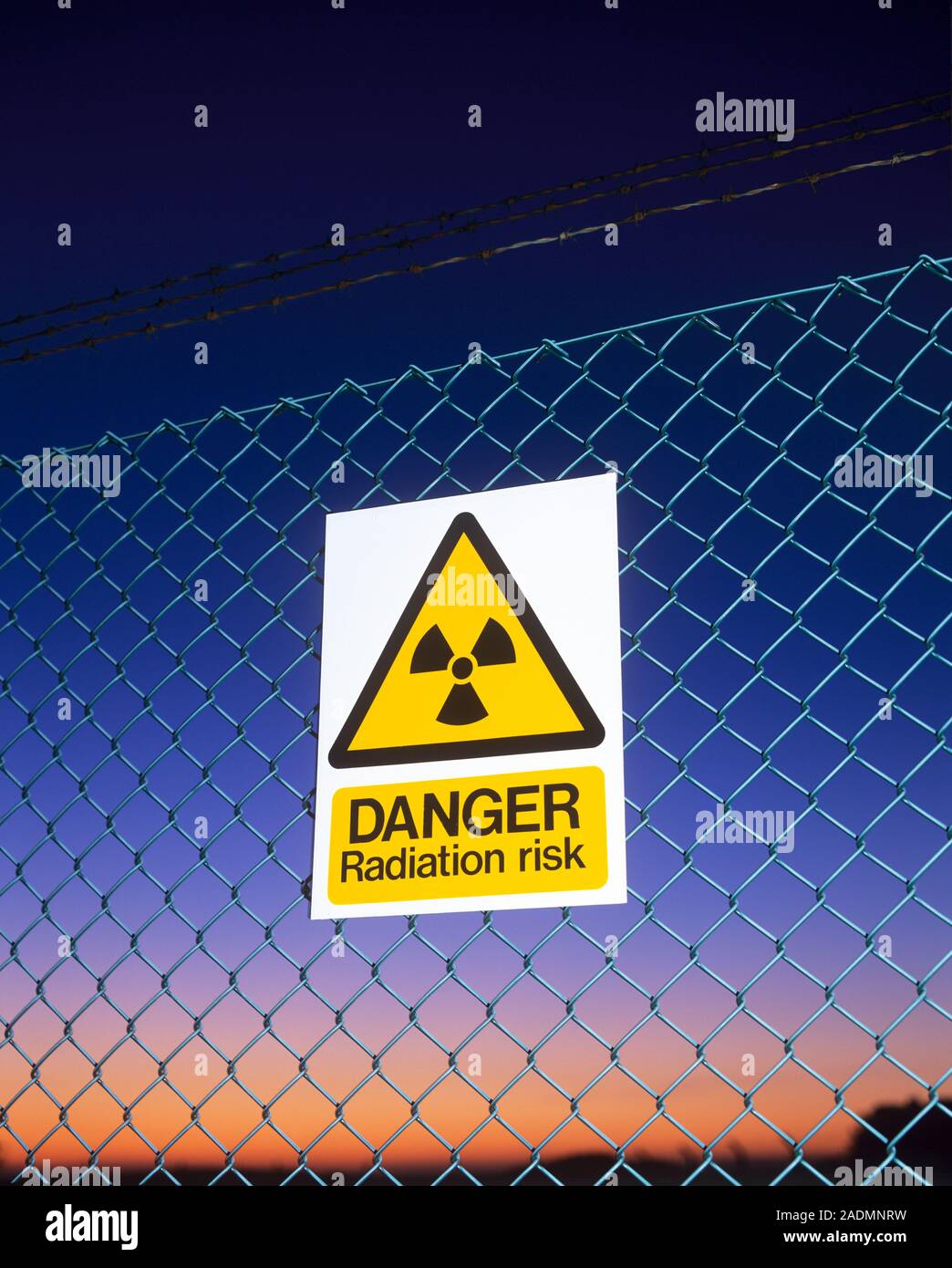 Radiation warning sign on a chain link fence Stock Photo - Alamy
