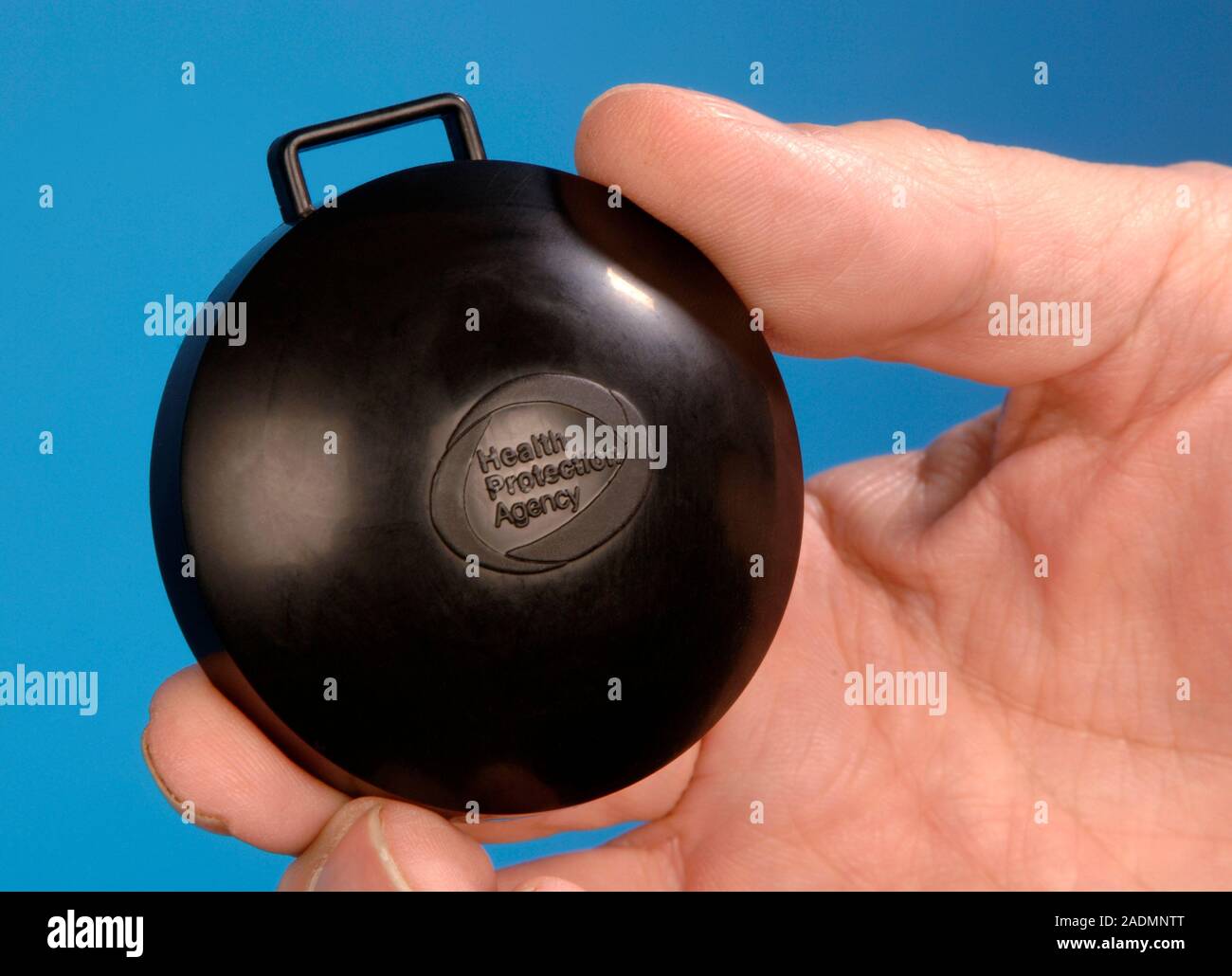 Radon detector held in a hand. This device is used to detect and ...