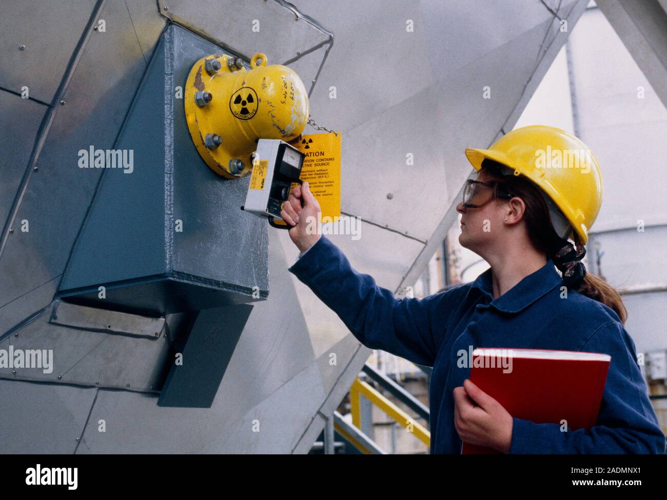 Checking a radioactive level gauge. Researcher using a radiation ...