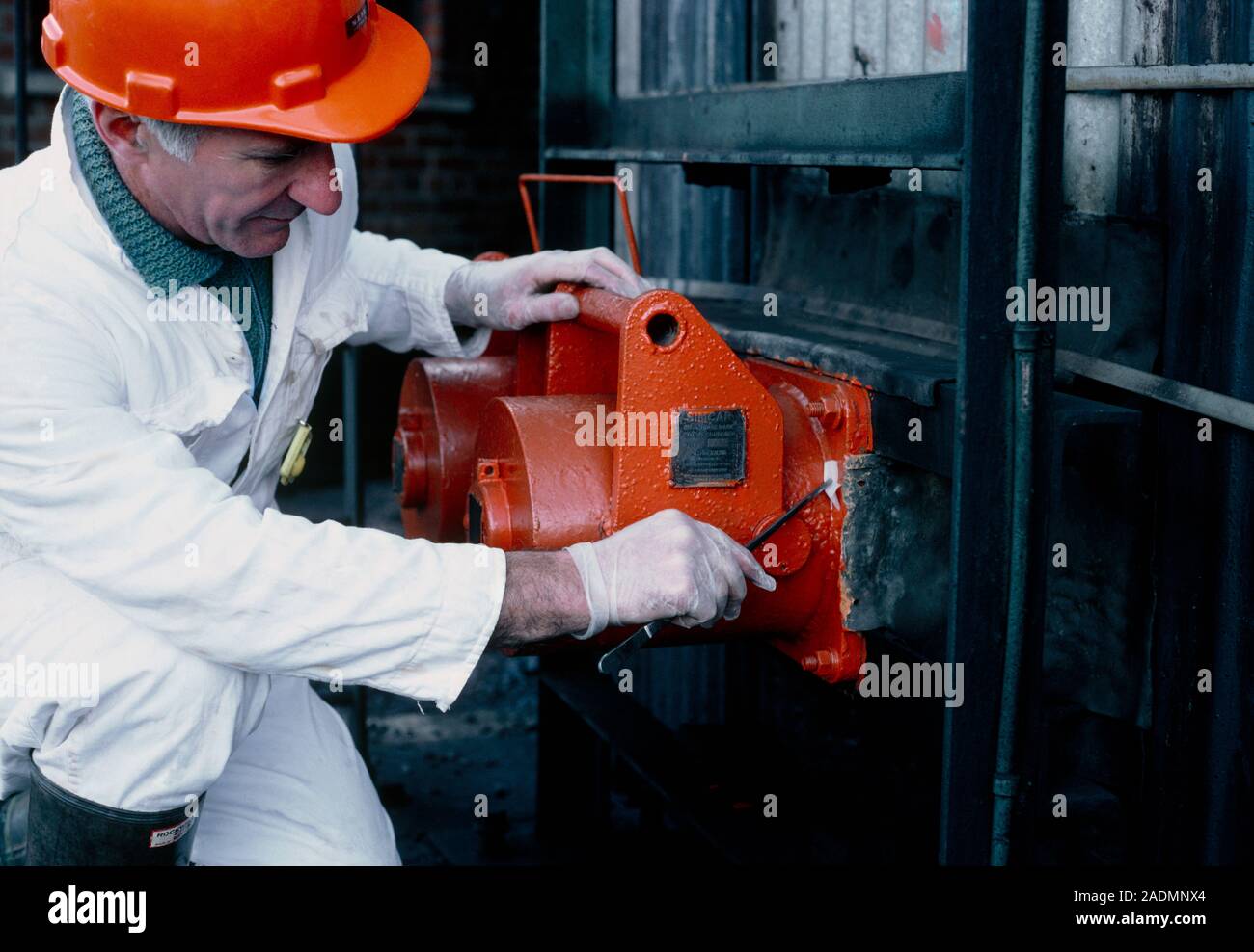 Wipe testing a radioactive level gauge. Researcher using a wipe test to ...