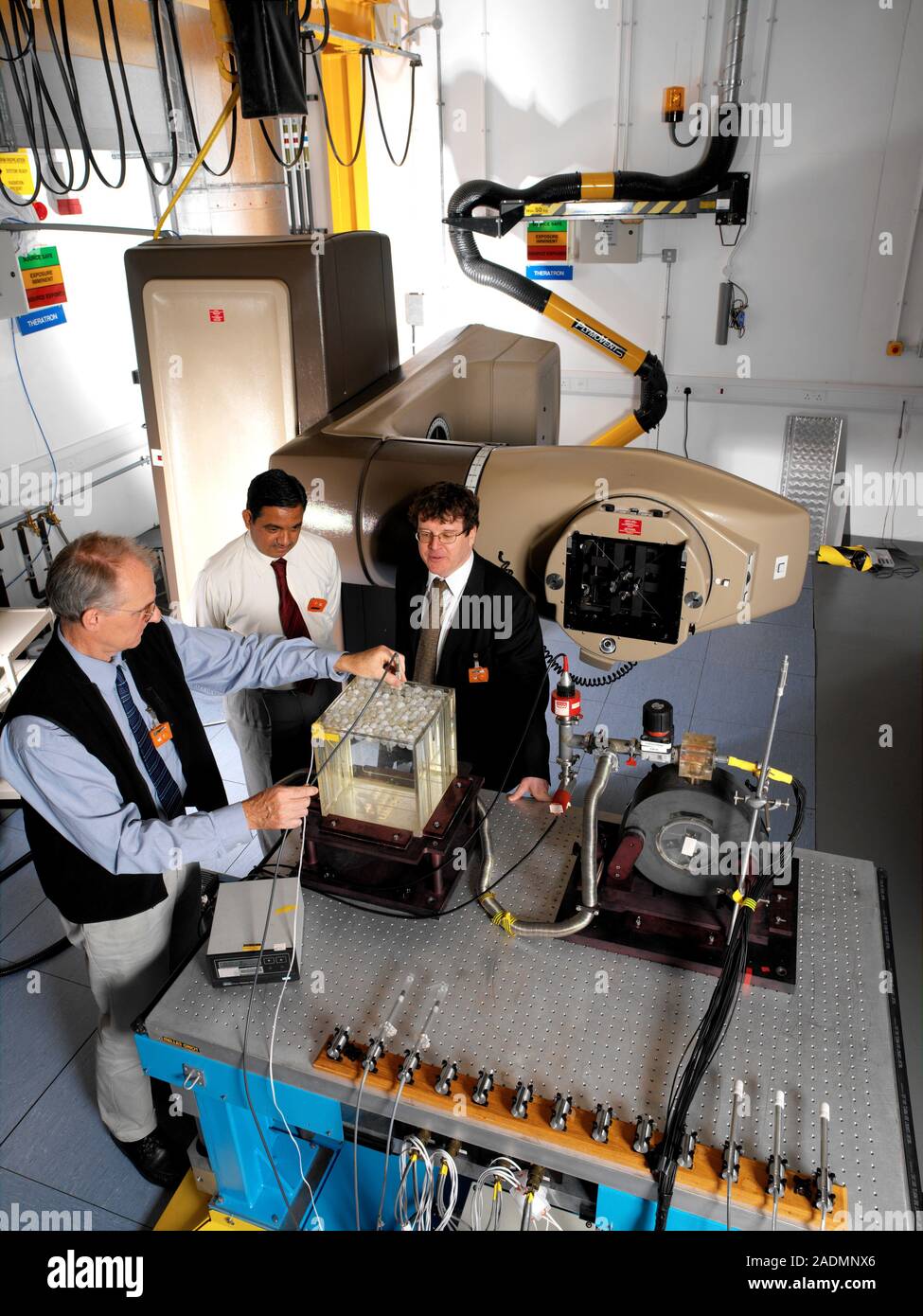 Gamma ray facility. Physicists using a cobalt-60 therapy level gamma ...