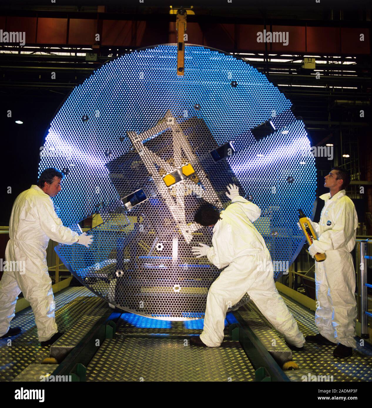 Nuclear power station construction. Workers with a tubing support plate ...